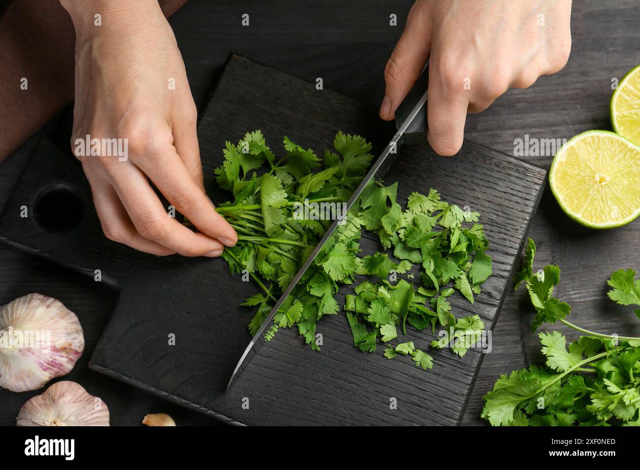 Woman cutting fresh coriander hi-res stock photography and images - Alamy