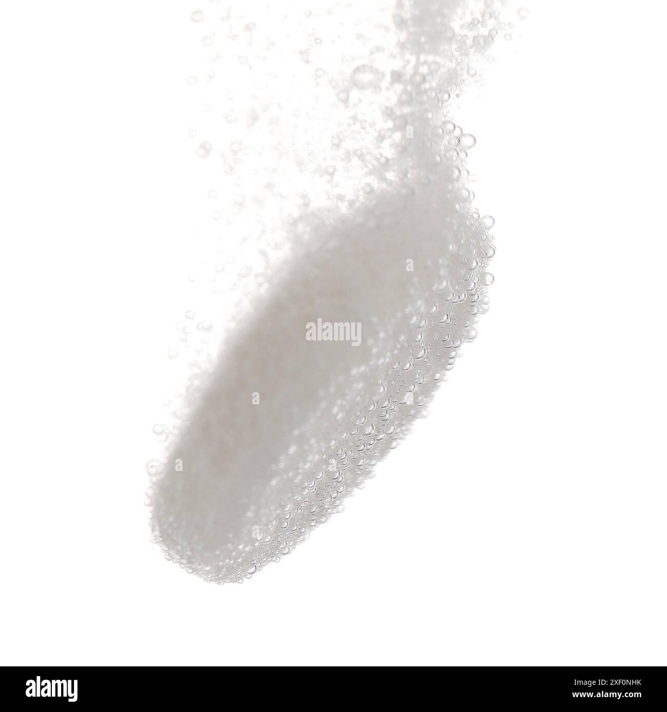 Effervescent pill dissolving in water on white background, closeup ...