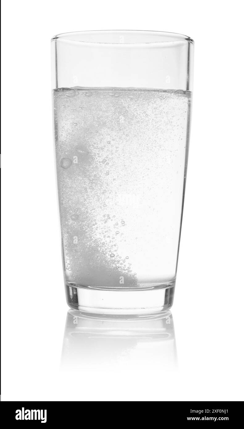 Effervescent pill dissolving in glass of water isolated on white Stock ...