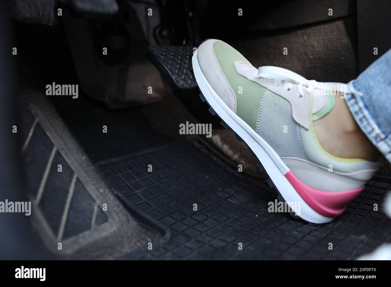 Woman pushing on pedal of car brake, closeup Stock Photo - Alamy
