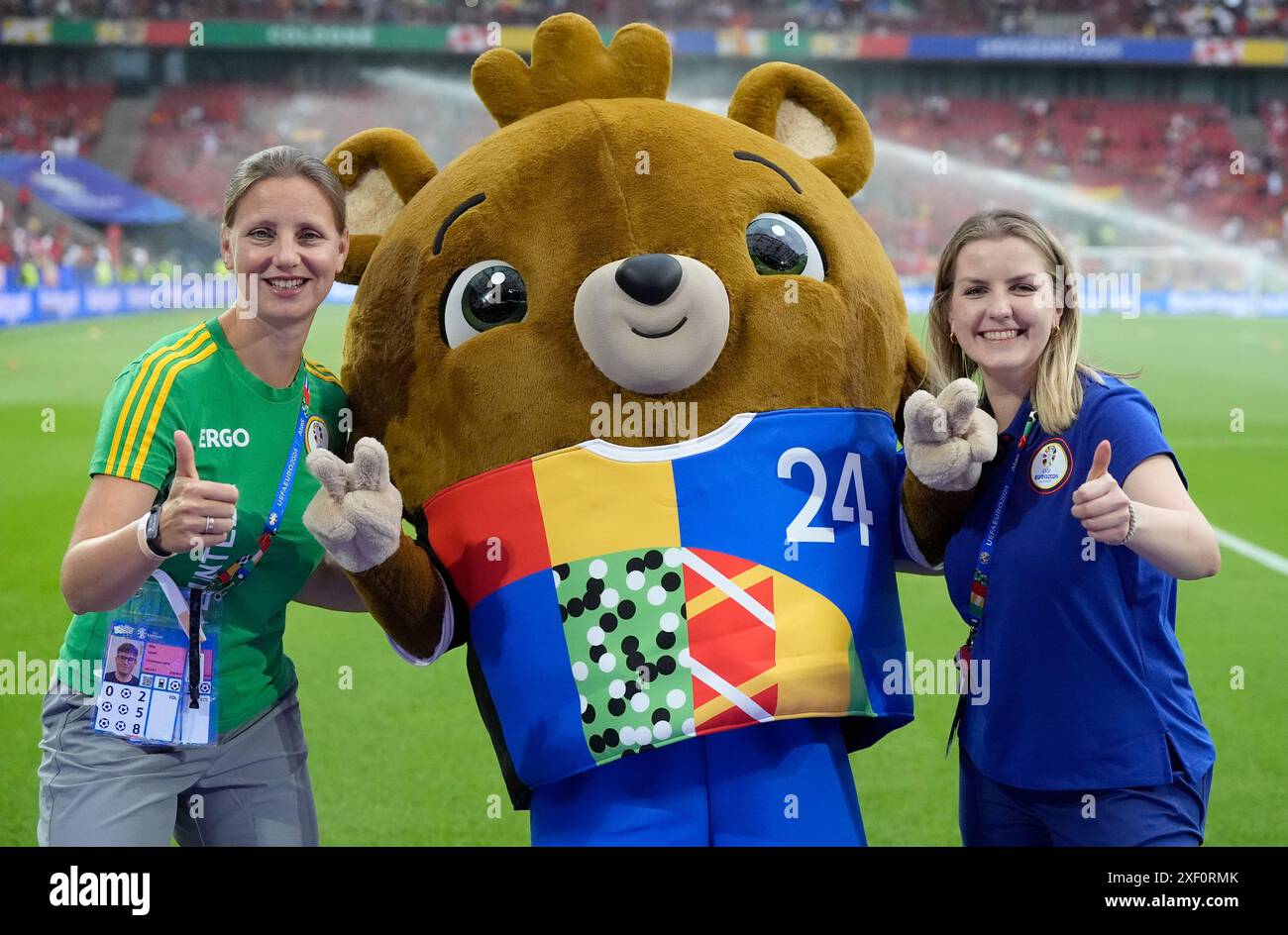 Euro 2024 tournament mascot Albart with two volunteers on the pitch ...