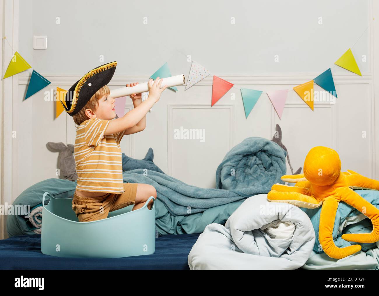 Boy dressed as pirate, using telescope in imaginative play Stock Photo ...
