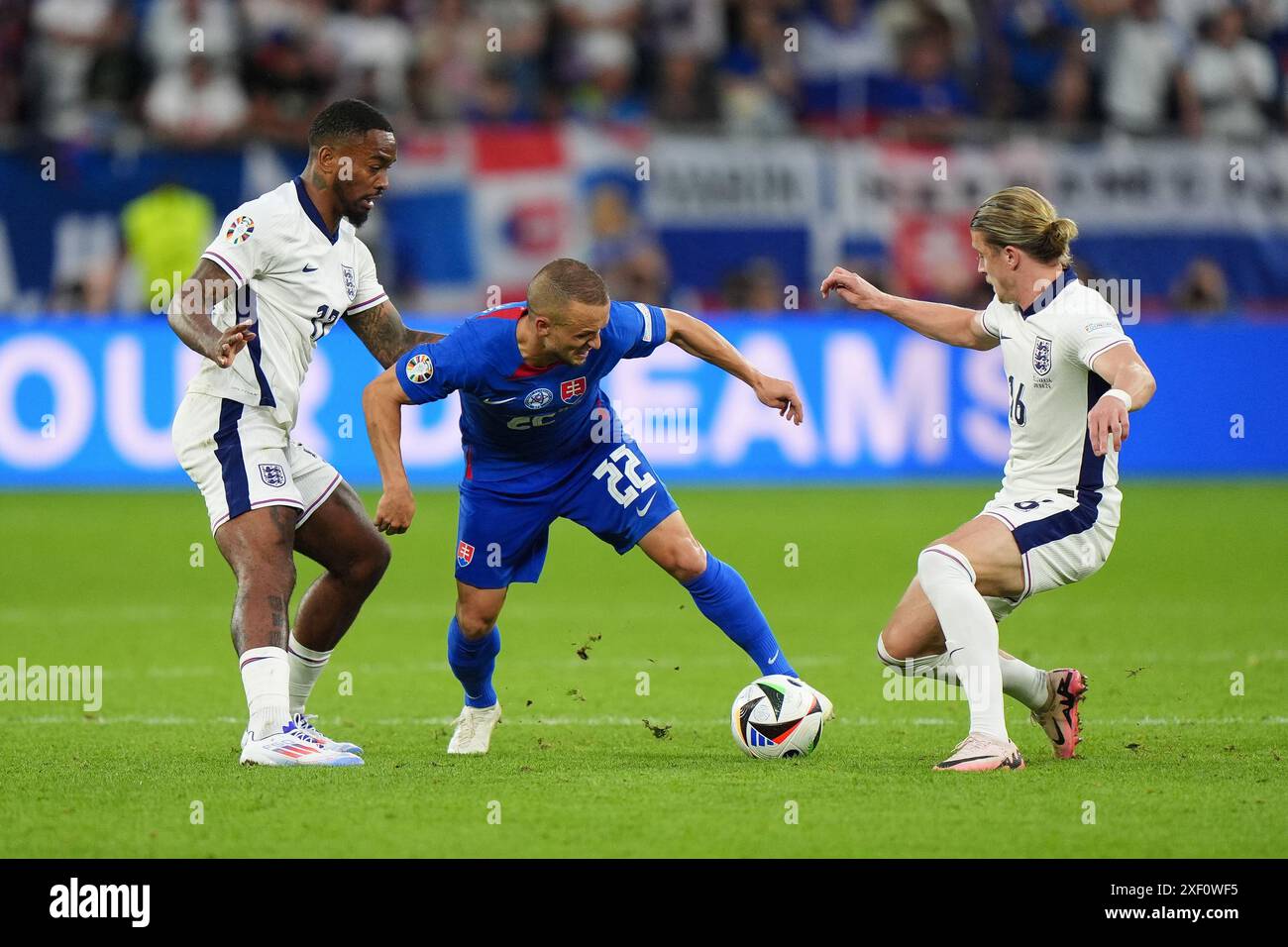 Slovakia's Stanislav Lobotka (centre) attempts to past England's Ivan Toney (left) and Conor ...