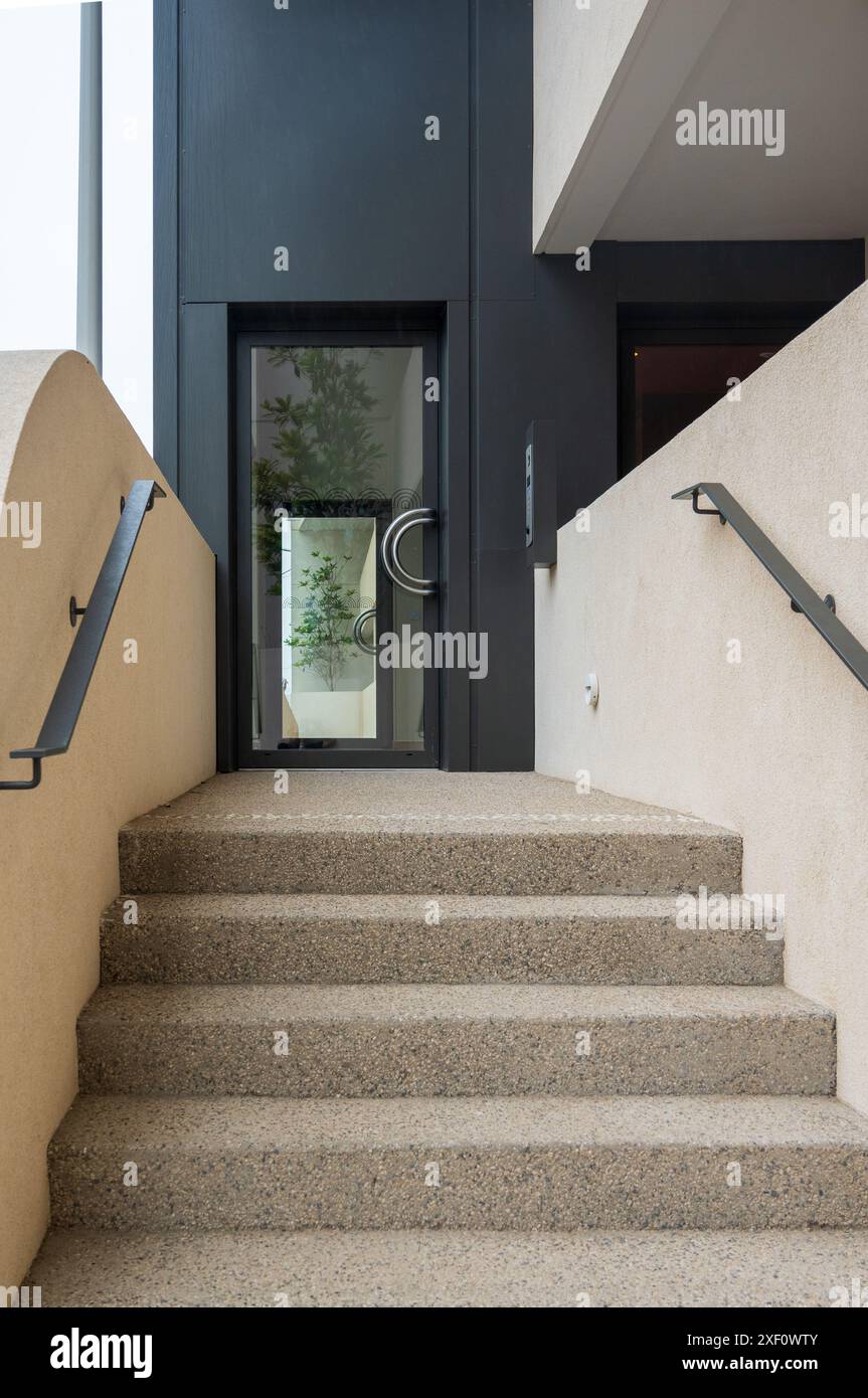 An entrance way to a block of luxury apartments with stairs and entry ...