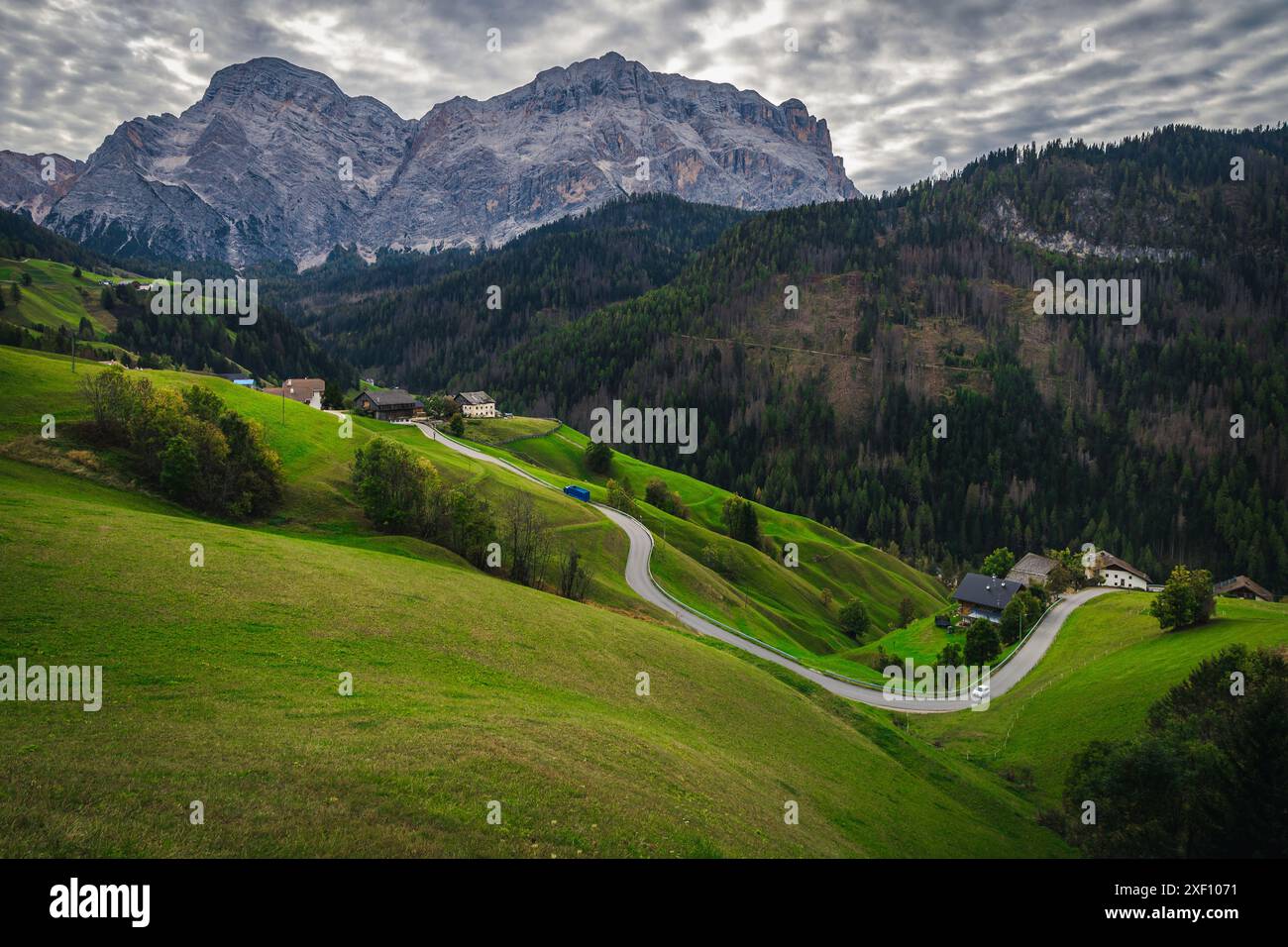 Amazing valley and mountain pass view with curved road on the green ...