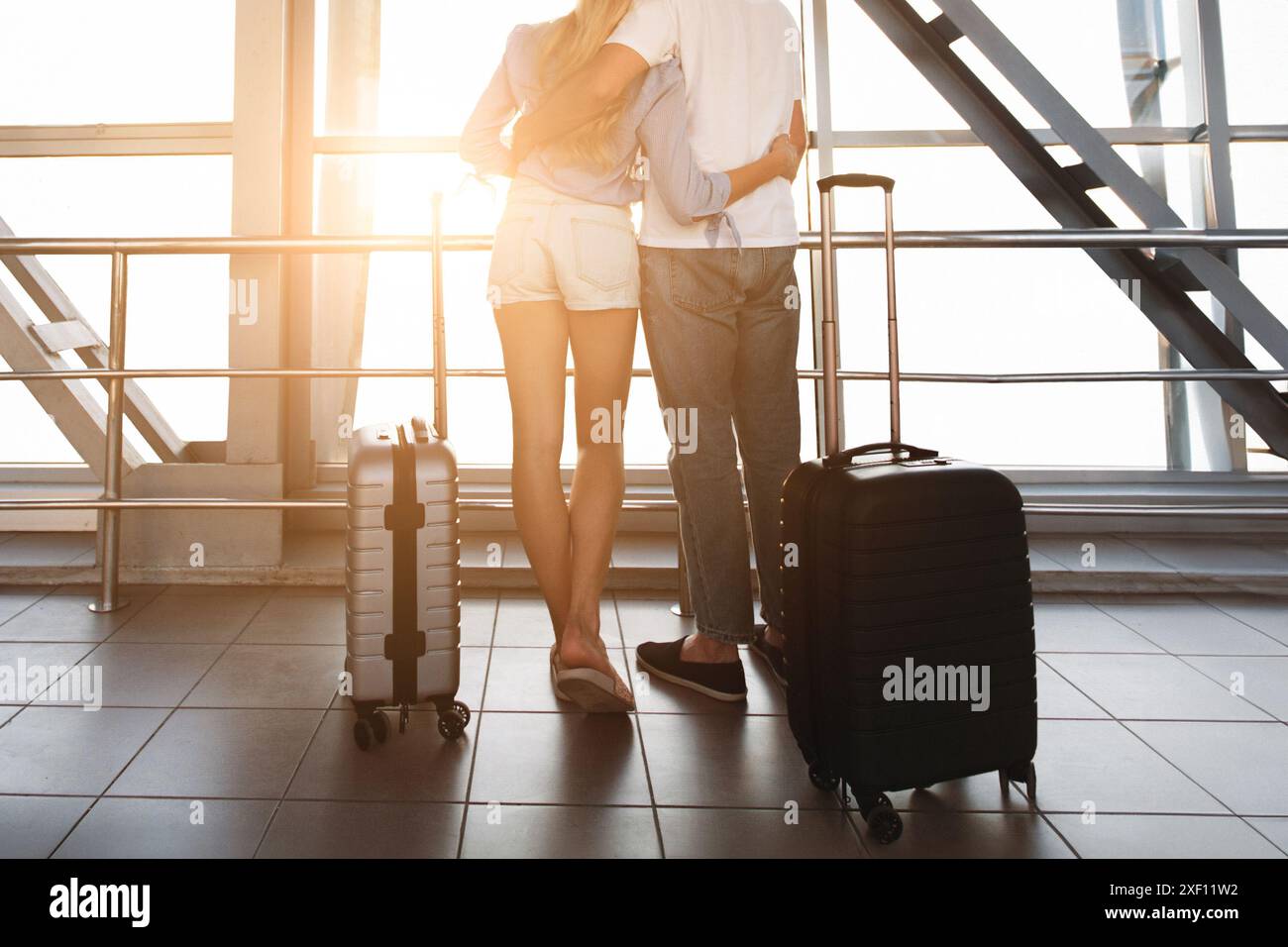 Traveling concept. Couple hugging in airport terminal Stock Photo - Alamy