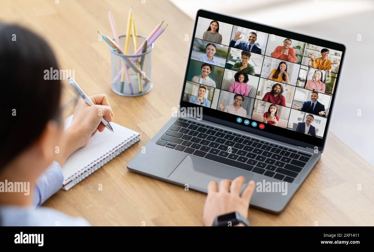 Lady Taking Notes During a Virtual Meeting on a Laptop Stock Photo - Alamy