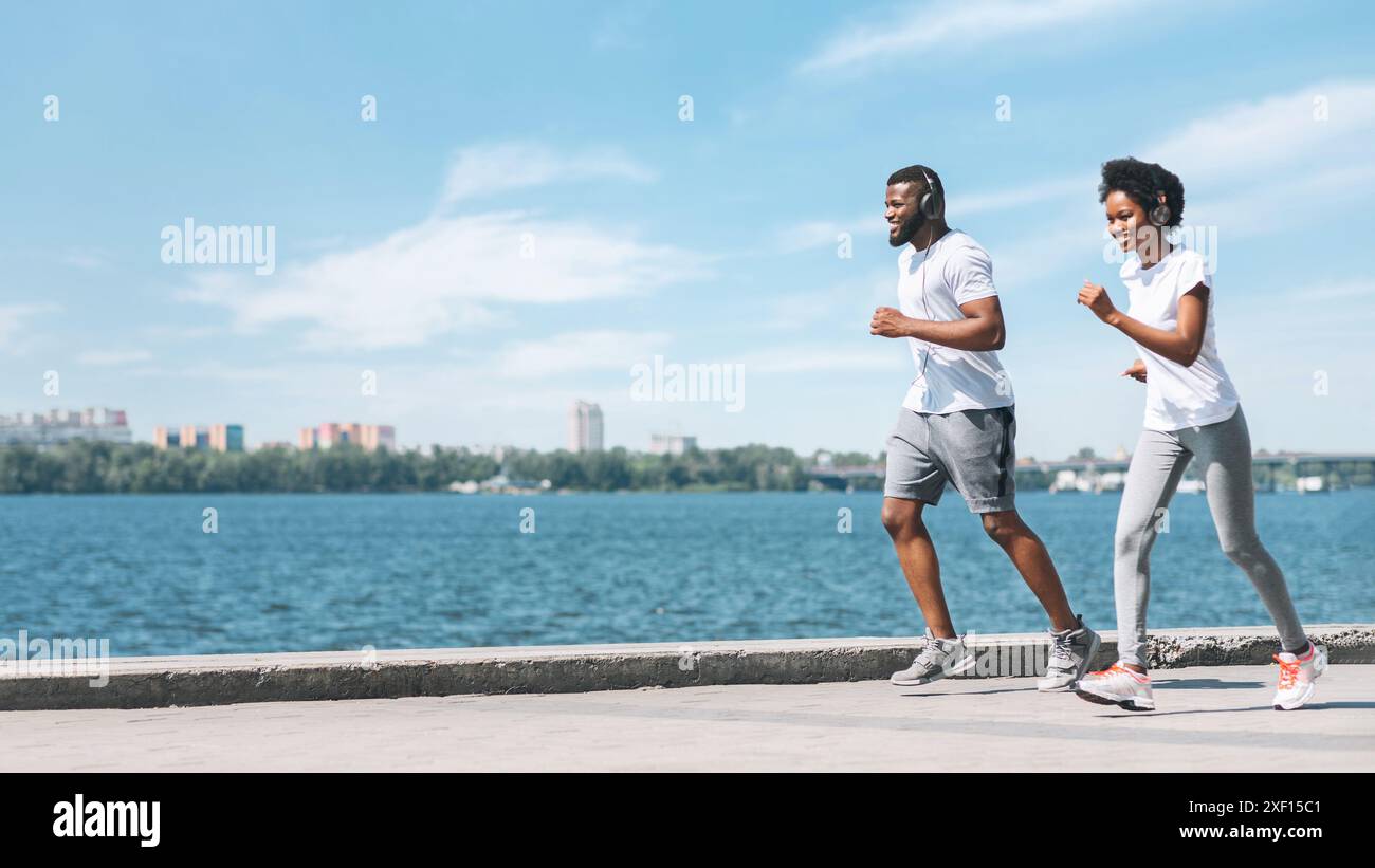Woman running along embankment hi-res stock photography and images - Alamy
