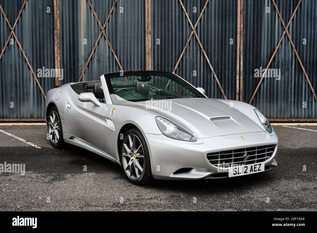 Silver Ferrari California convertible car with its roof down outdoors ...