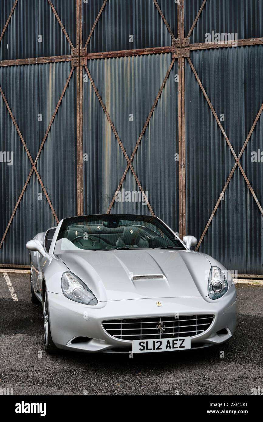 Silver Ferrari California convertible car with its roof down outdoors ...
