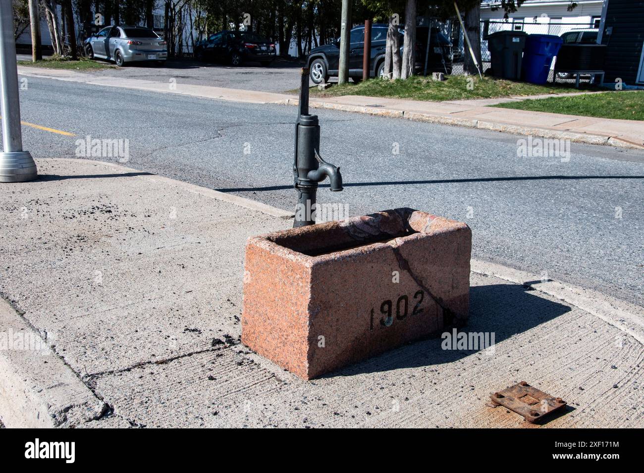 Vintage communal water pump and trough on Portage Street in downtown St ...