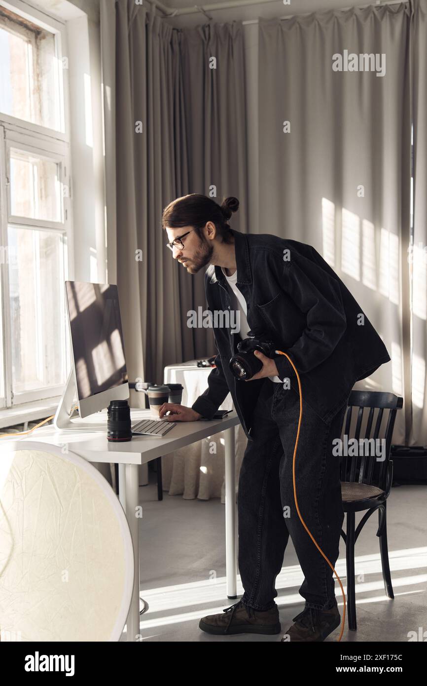 Vertical full length portrait of young professional photographer ...