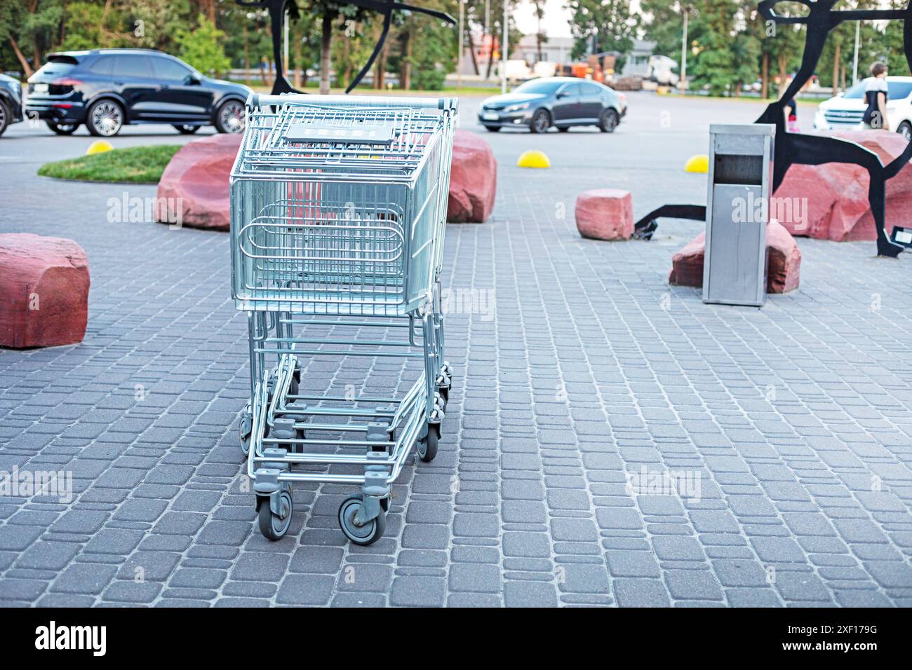 metal carts for products stacked on top of each other outside near a ...