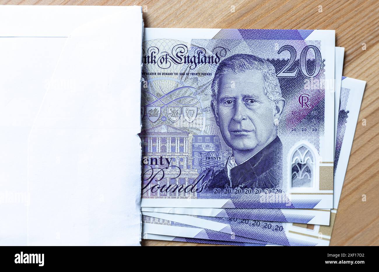 Cash in envleope, banknotes featuring a portrait of King Charles III ...