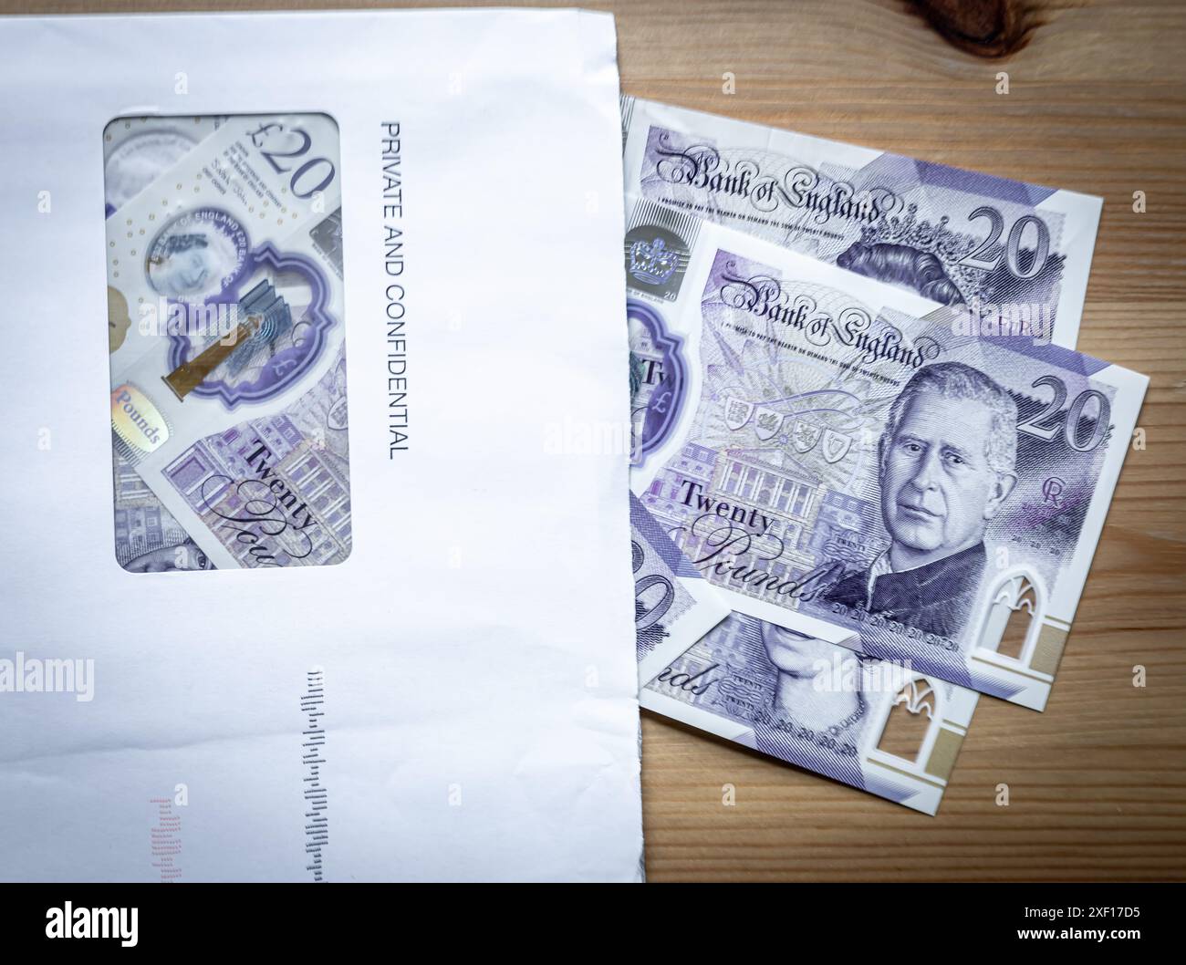 Cash in envleope, banknotes featuring a portrait of King Charles III ...