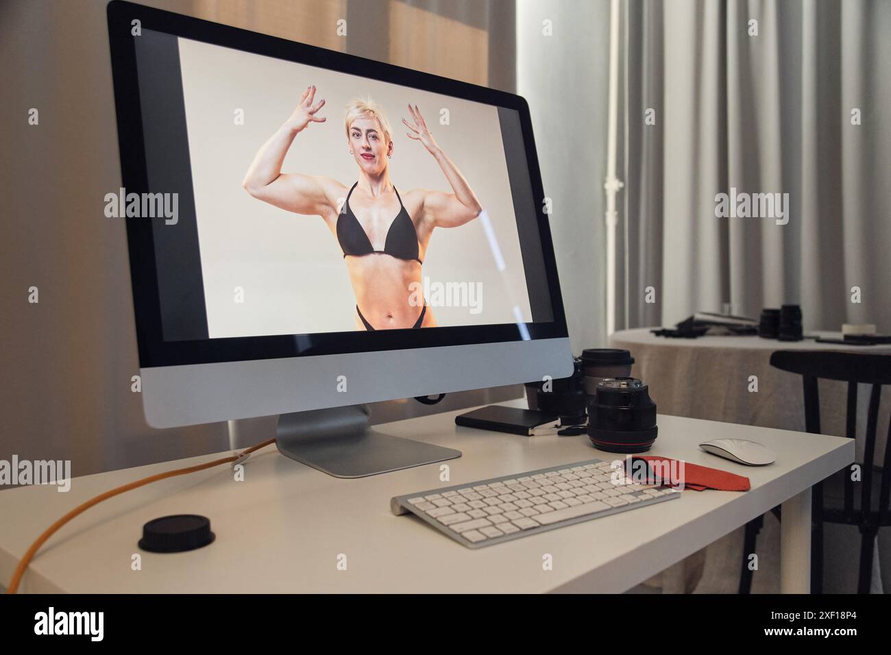 Close up background image of computer in photo studio with portrait of smiling female ...