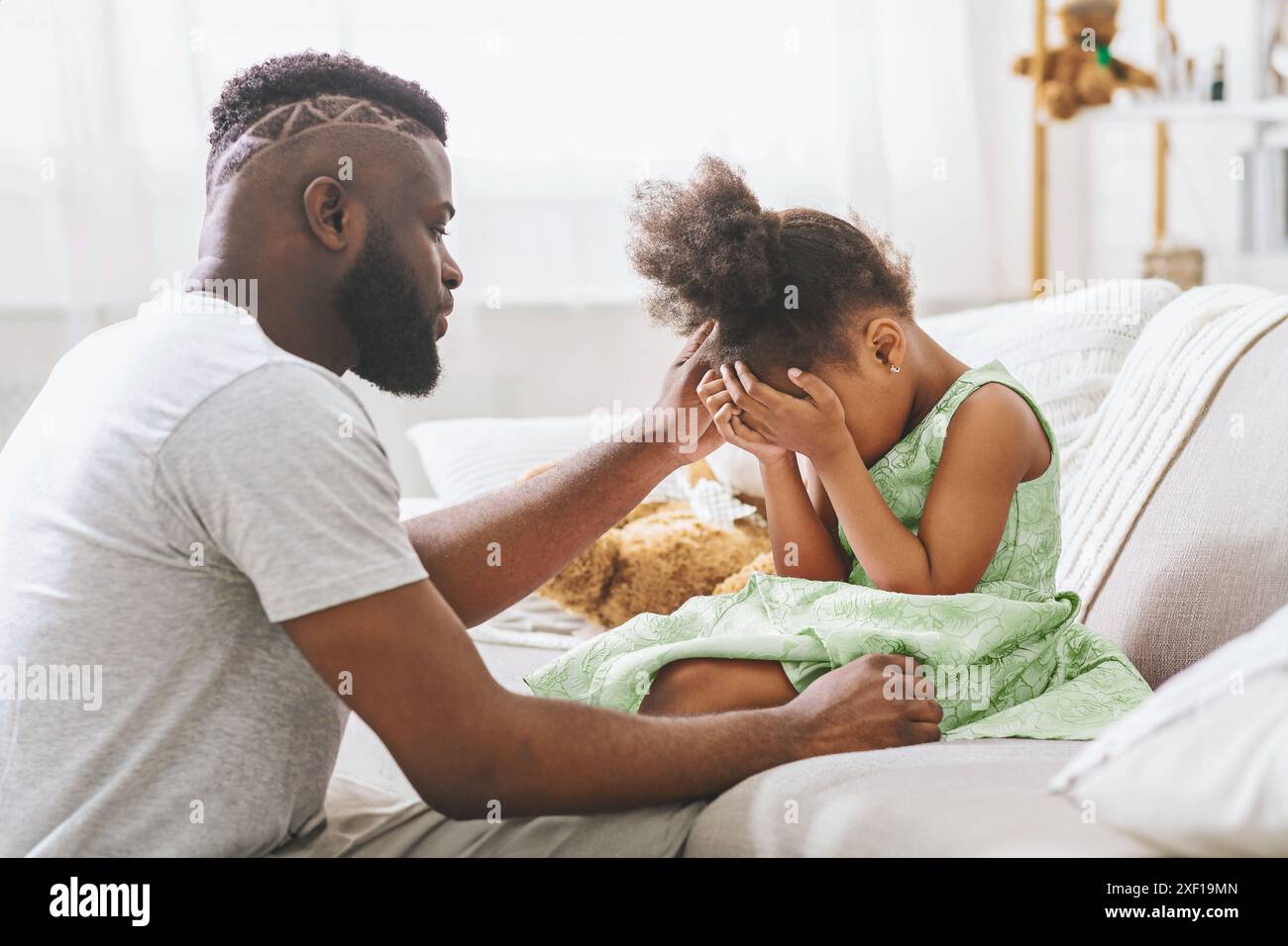 Father Comforting Upset Daughter on Couch at Home Stock Photo - Alamy