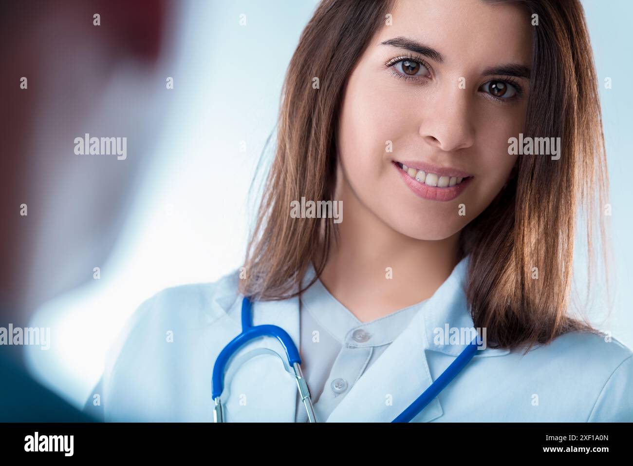 Young doctor is listening carefully to her patient during a medical ...