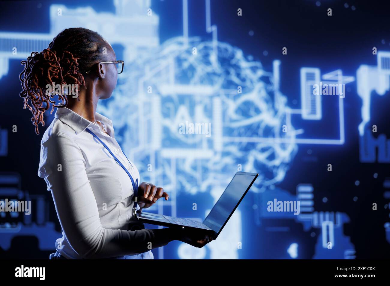 IT consultant uses laptop to develop artificial intelligence neural networks nodes modeled after ...