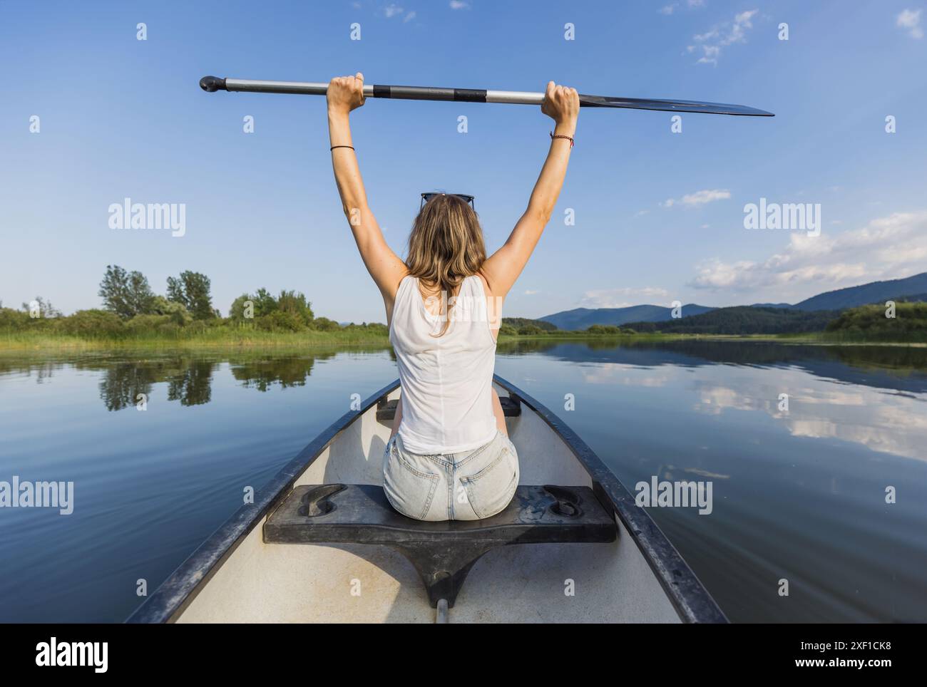 Woman enjoying an amazing summer nature scene while canoeing in the ...