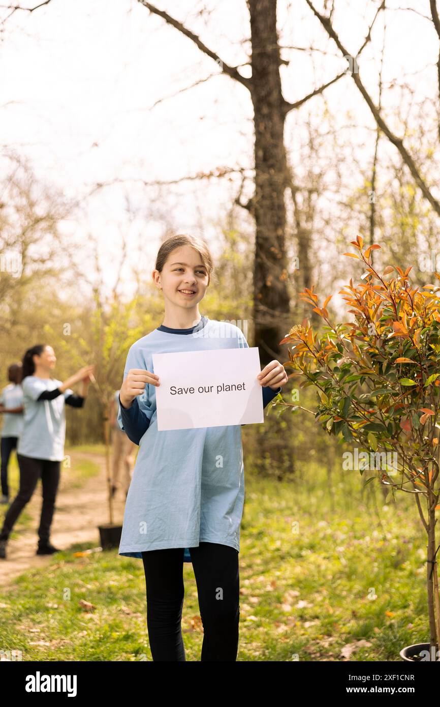 Portrait of young kid advertising banner with save our planet message ...