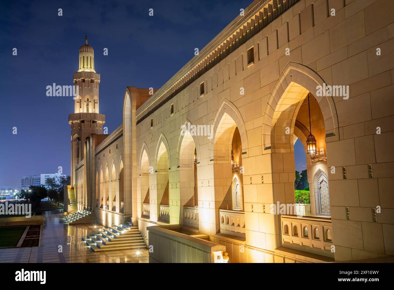 Sultan Qaboos Grand Mosque decorated walls and minaret shining at night ...
