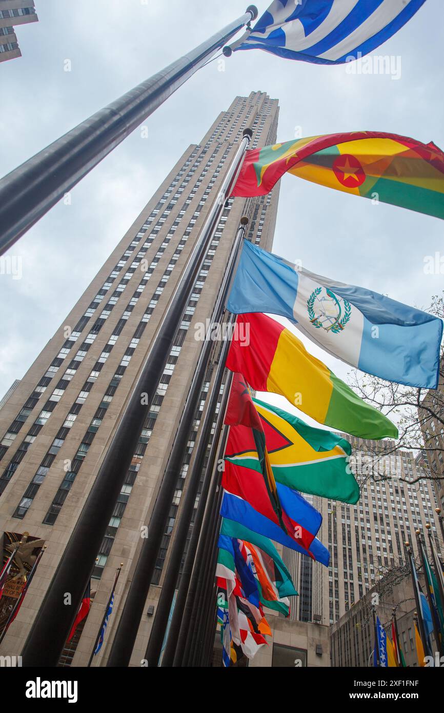 Vertical image of the Country Flag poles and the facade of the Rockefeller Center Midtown ...
