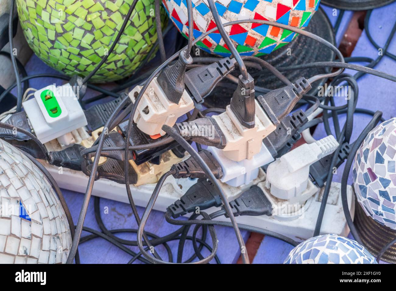 Old and damaged electric adapter power plug has many appliances are ...