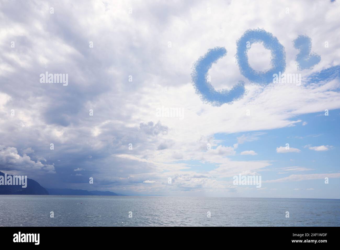 Blue sky with CO2 chemical formula and clouds over sea. Carbon dioxide ...
