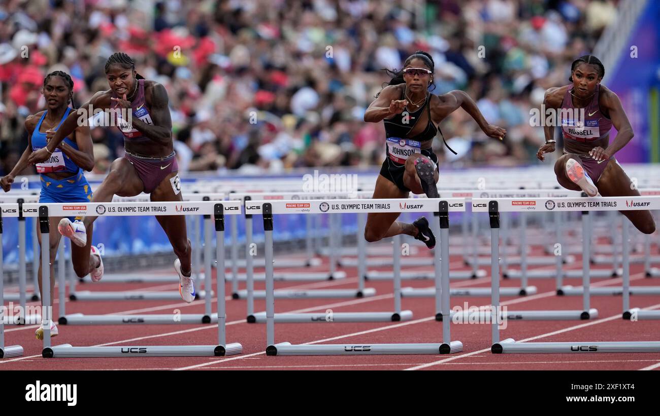 Masai Russell, right, runs the women's 100-meter hurdles final during ...