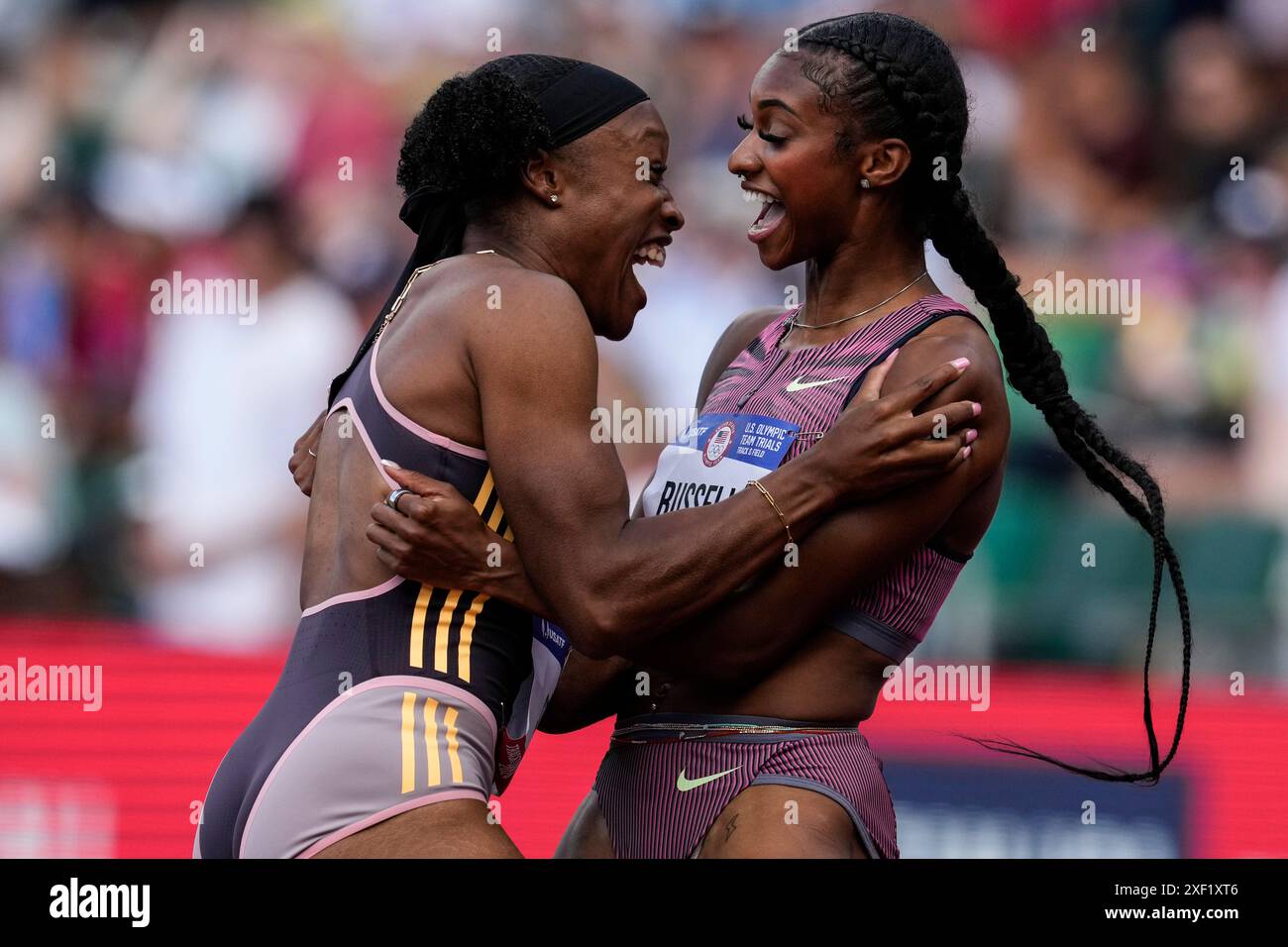Masai Russell, right, reacts to winning the women's 100-meter hurdles ...