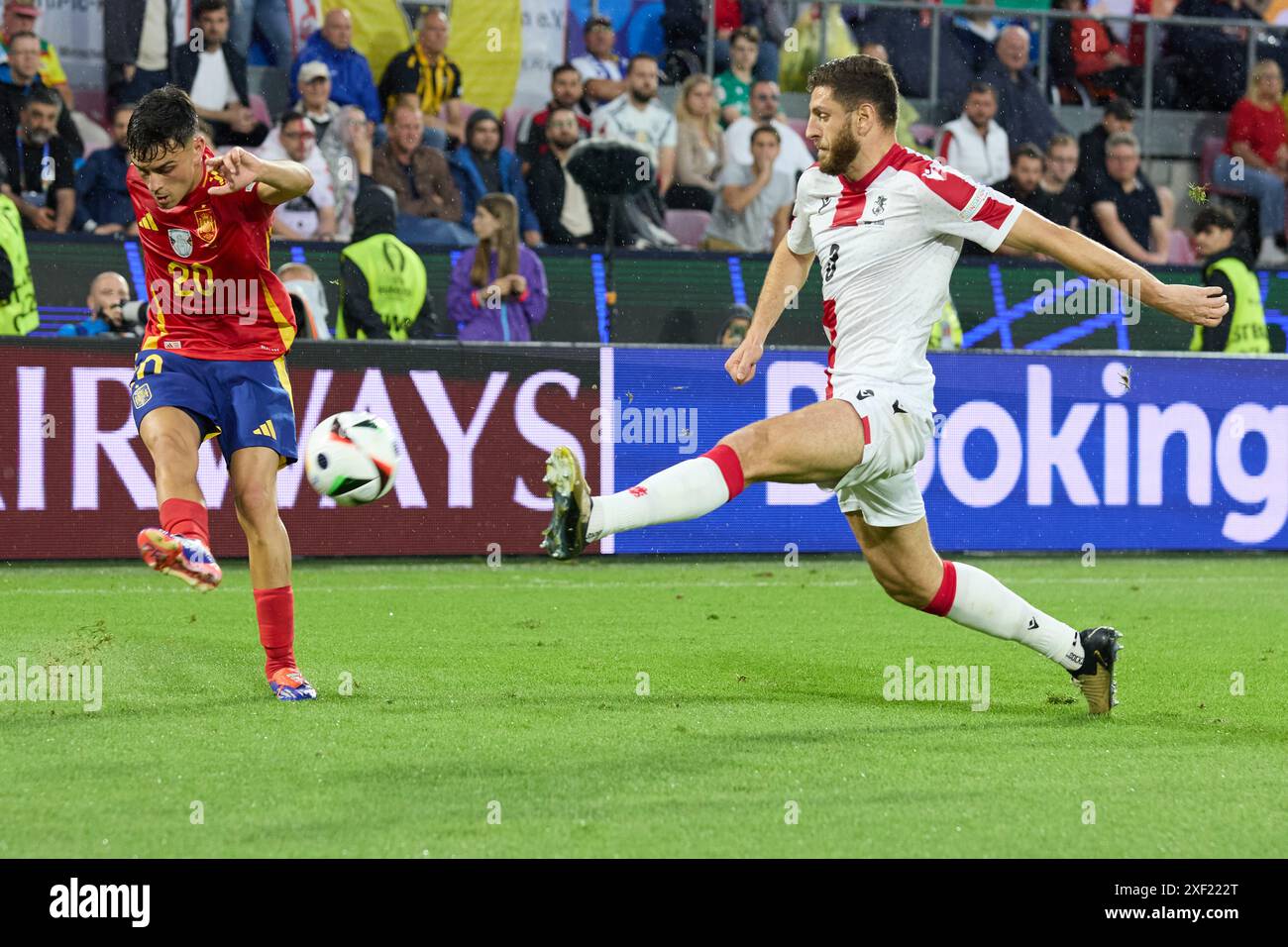 Cologne. 30th June, 2024. Pedro Gonzalez Lopez (L) of Spain shoots ...