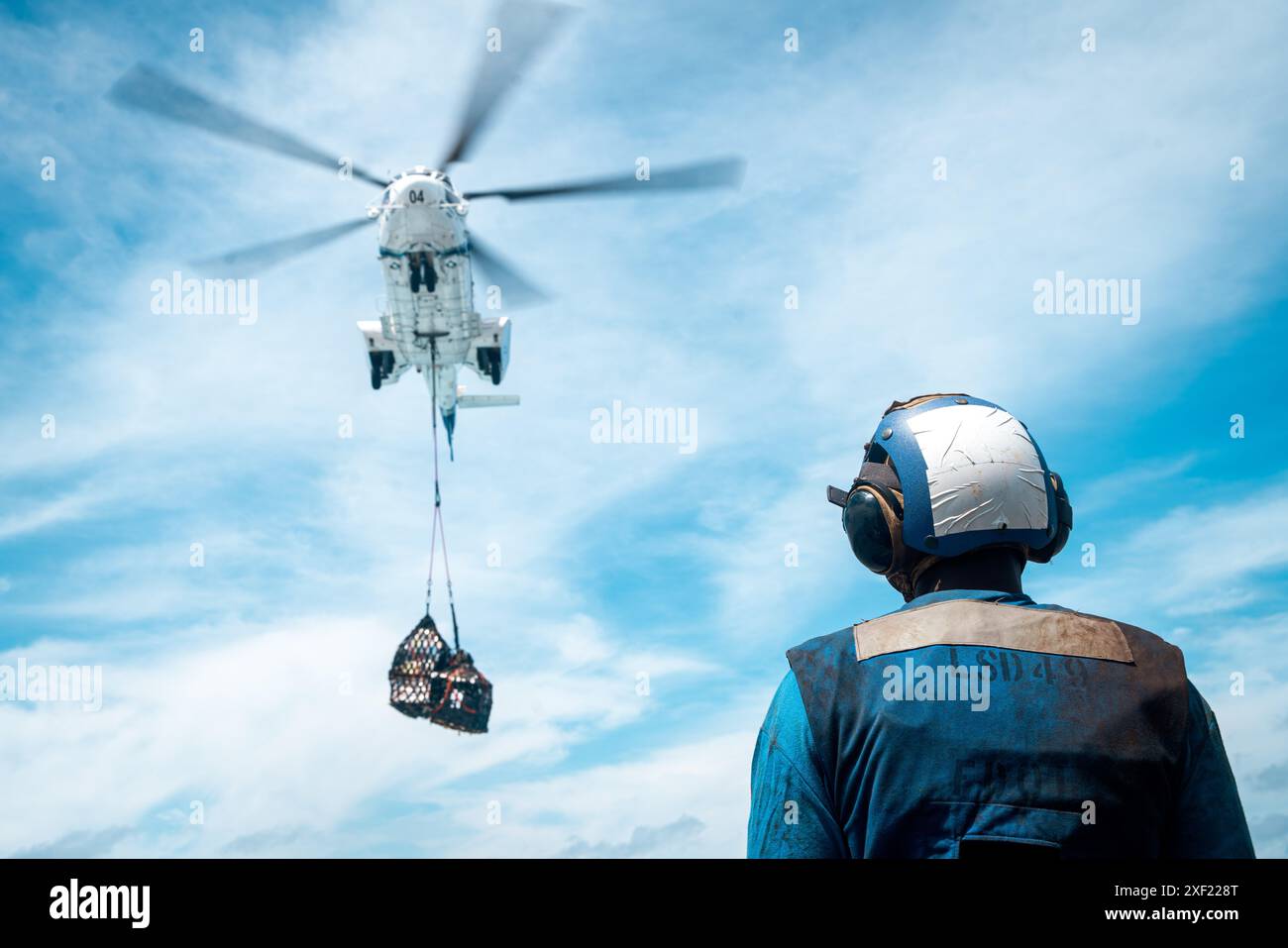 A U.S. Sailor assigned to the amphibious dock landing ship USS Harpers ...