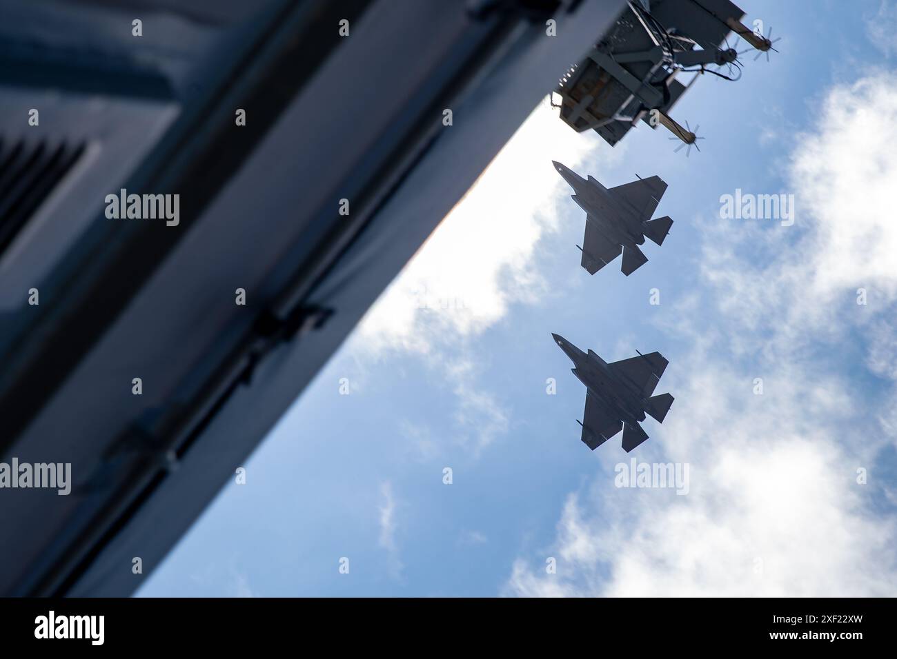 Two F-35C Lightning II’s, attached to Strike Fighter Squadron (VFA) 147, perform a flyover of ...