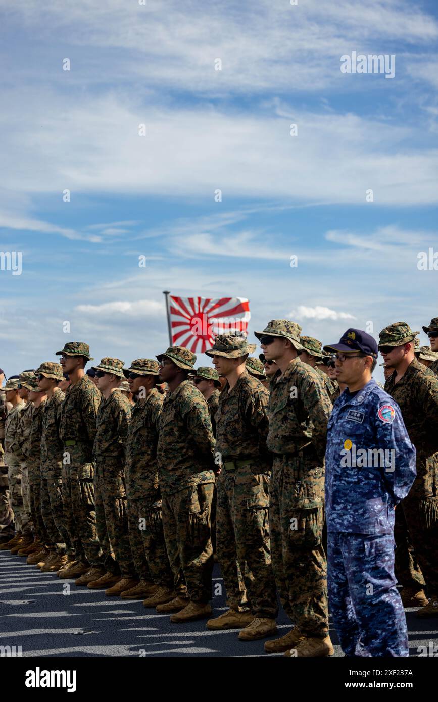 U.S. service members, French soldiers, and Japanese sailors stand in ...