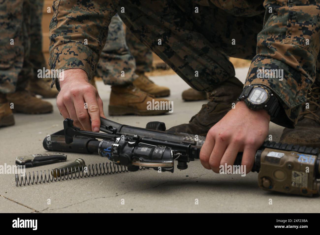 A U.S. Navy corpsman with 1st Marine Division assembles an M4 carbine ...