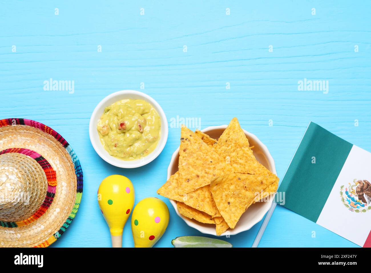 Mexican flag, sombrero hat, maracas, nachos chips and guacamole on ...