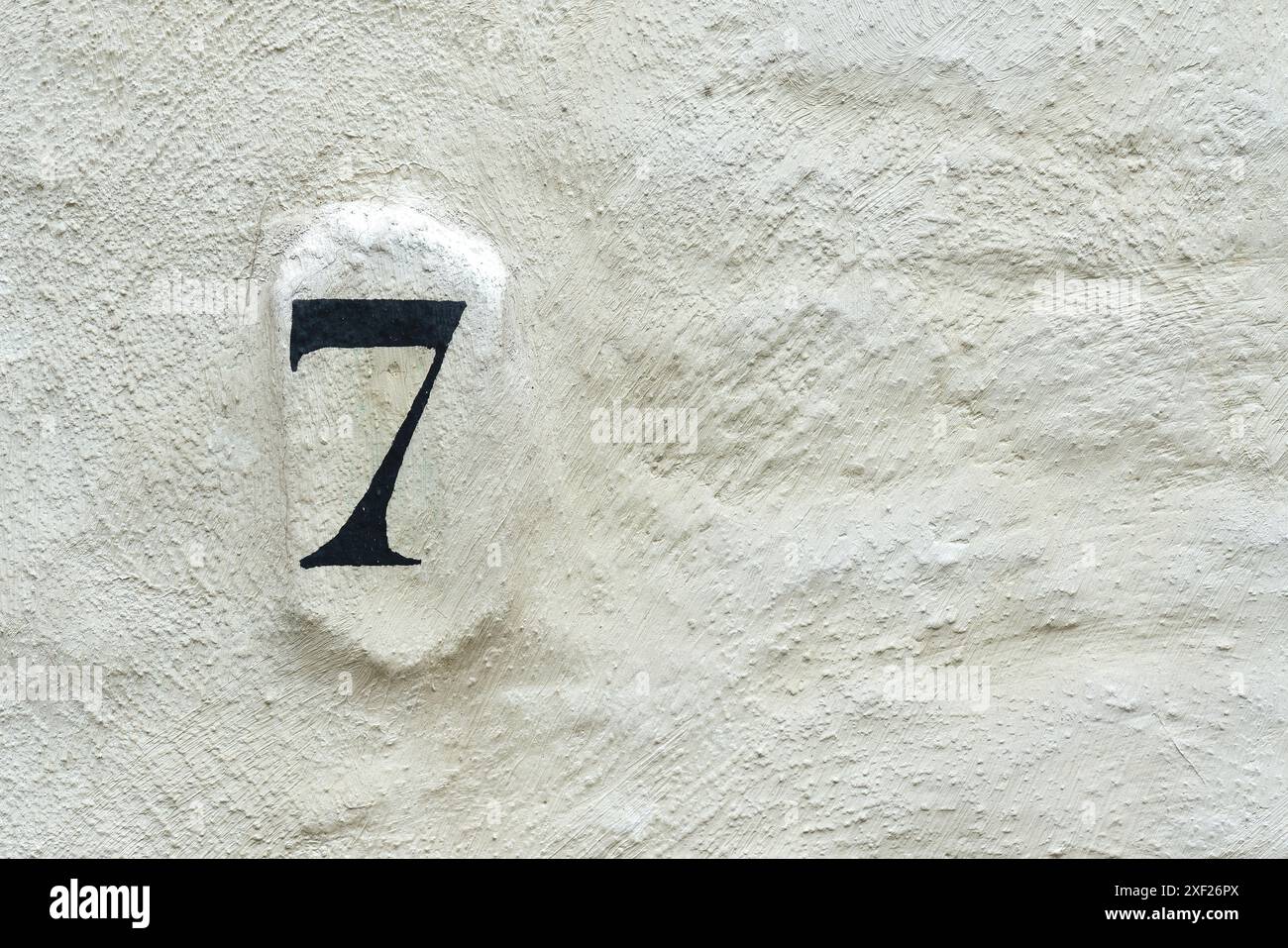 House number 7 on the facade of an old house in the old town of Bruges ...