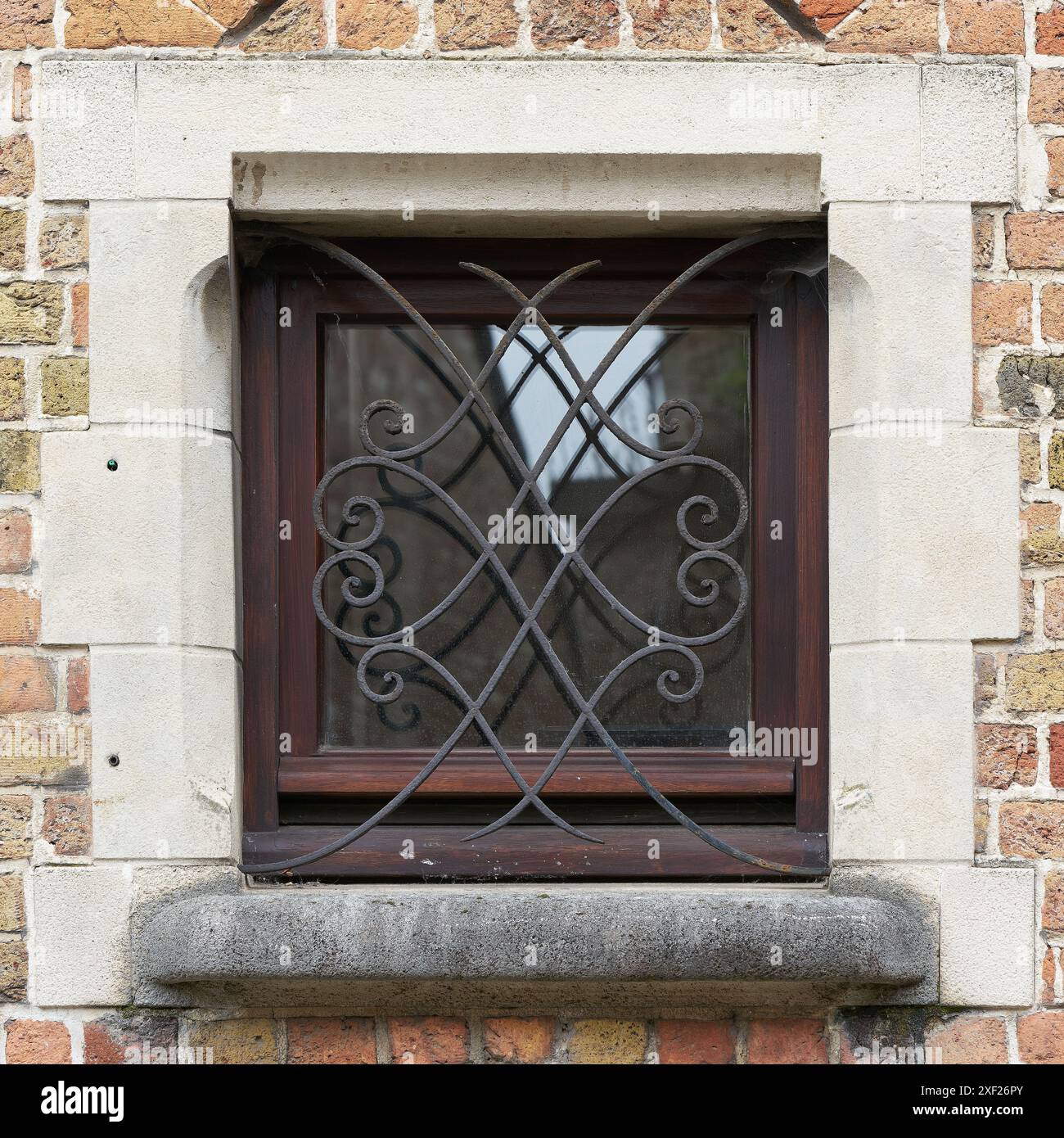 Window of a historic house with window grille in the old town of Bruges ...