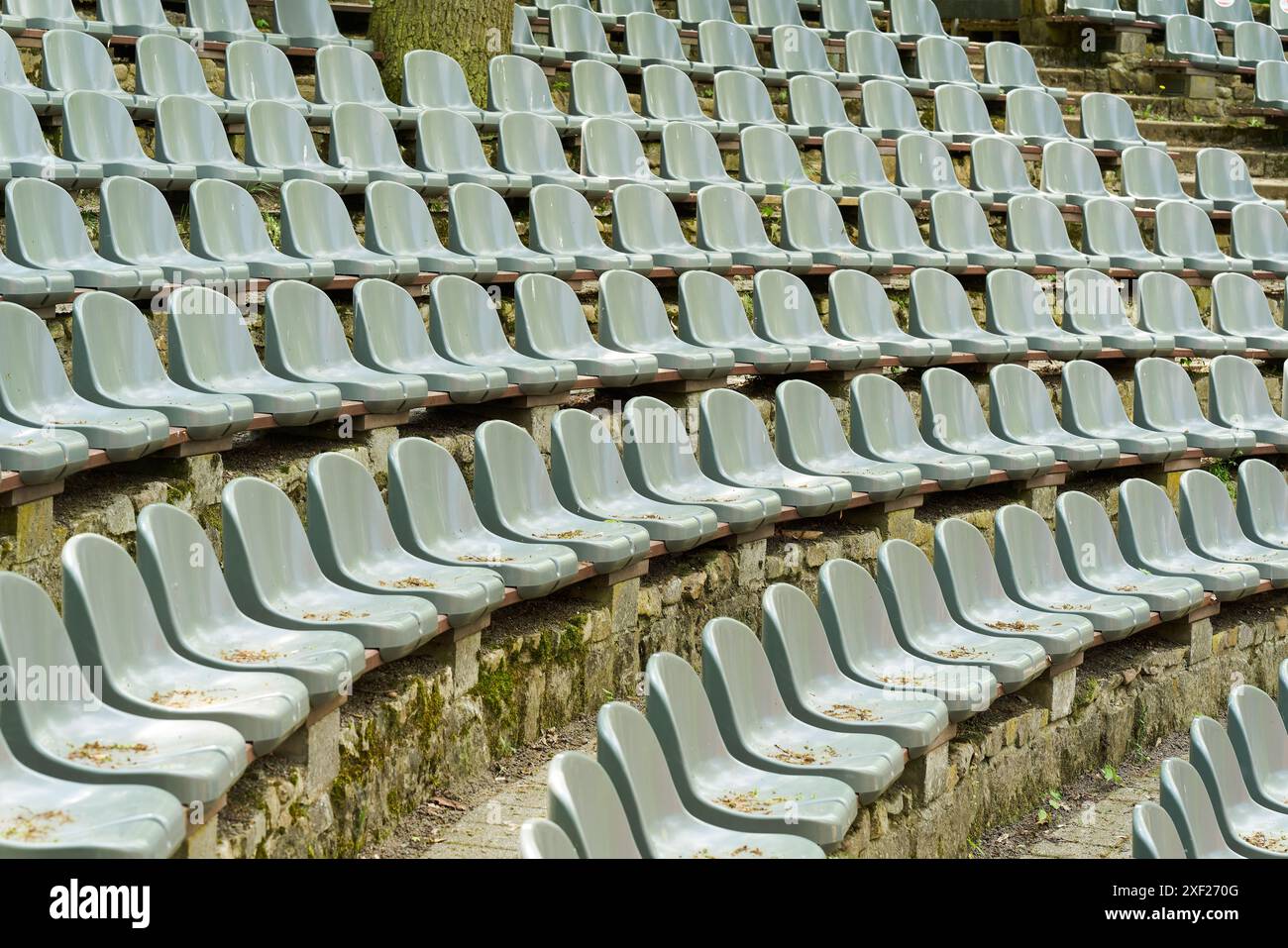 Rows of seats for spectators at a venue with an open-air stage in ...