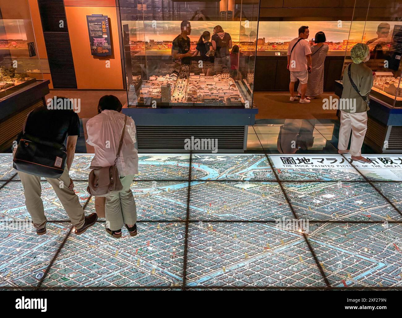 Visitors are viewing map of Osaka city on the floor during their visit ...