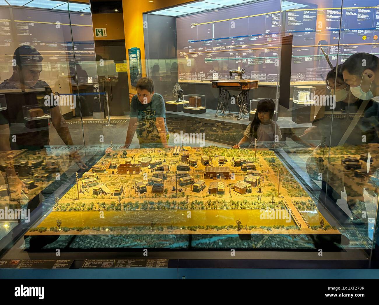 Visitors looking models of Osaka city during their visit to the Osaka ...