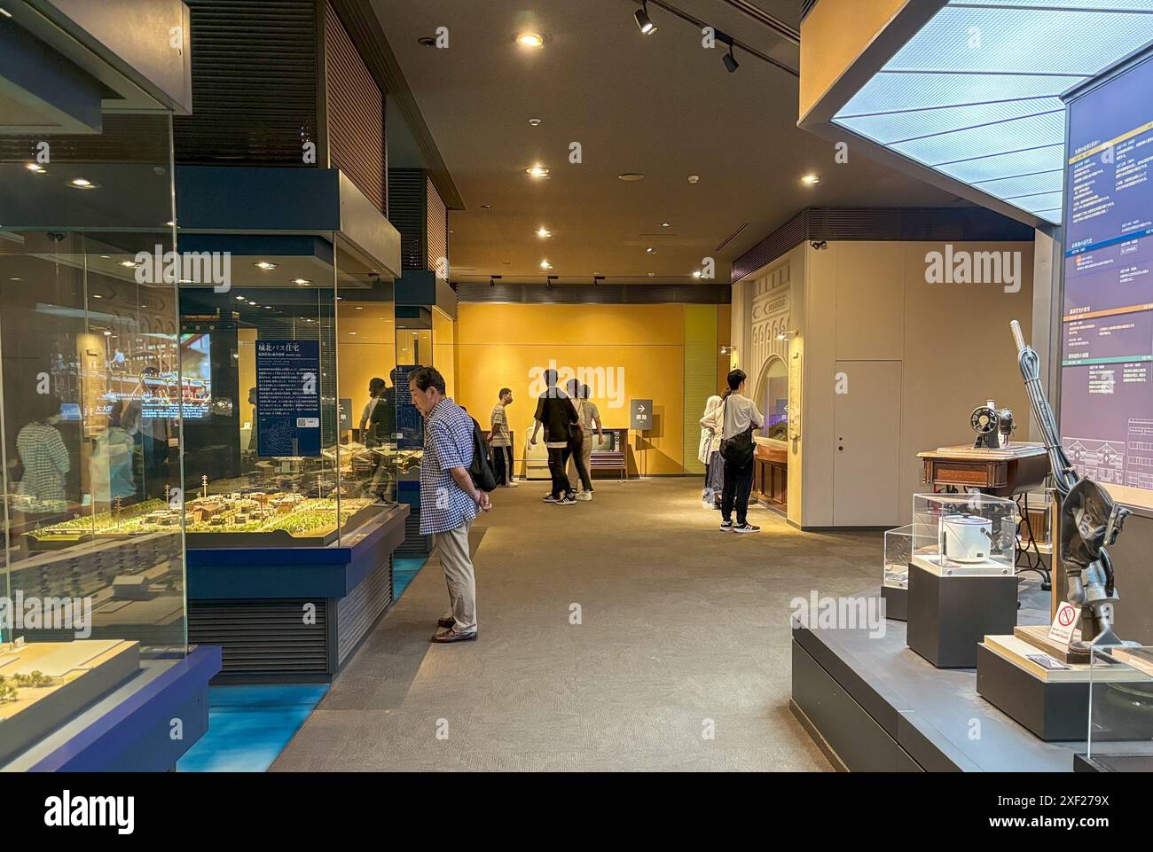 Visitors looking models of Osaka city during their visit to the Osaka ...