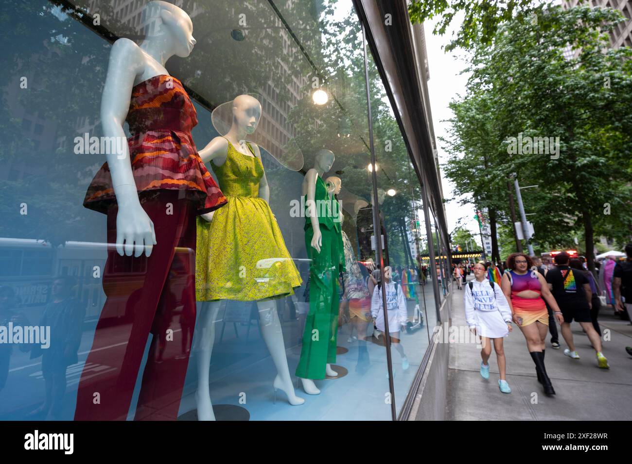 Seattle, Washington, USA. 30th June, 2024. Spectators pass a window ...