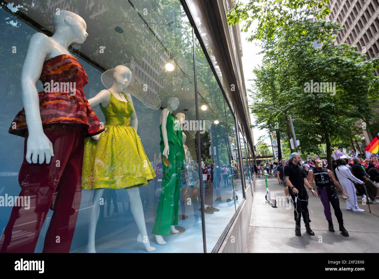 Seattle, Washington, USA. 30th June, 2024. Spectators pass a window ...