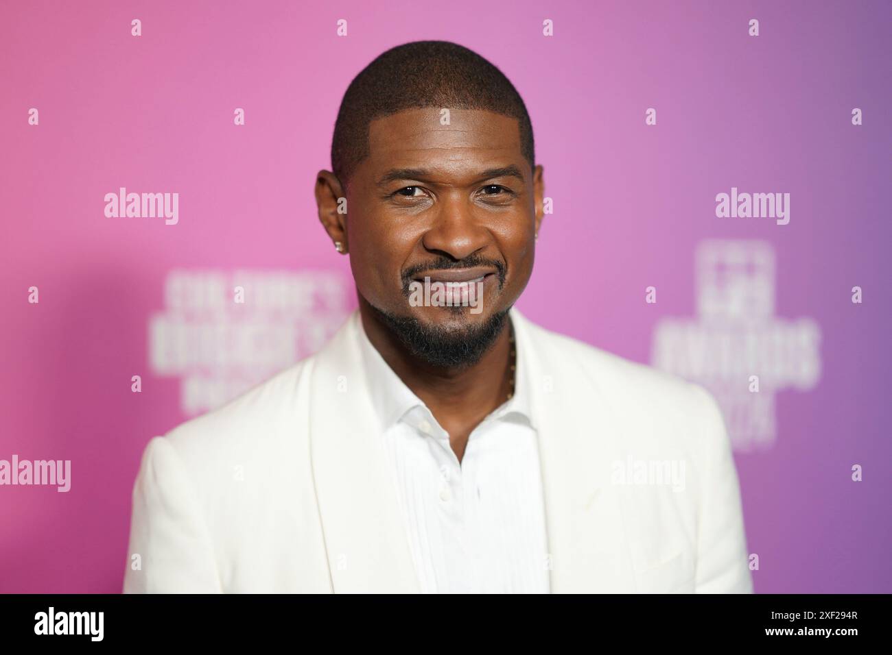 Usher, recipient of the Lifetime Achievement award, poses in the press ...