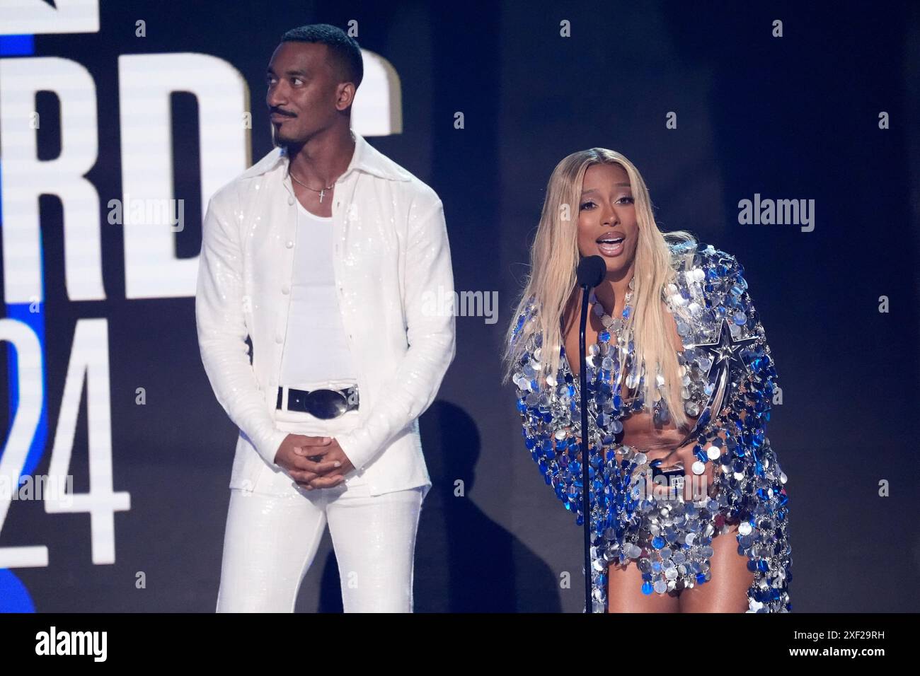 Victoria Monet, center, accepts the award for video of the year for "On ...