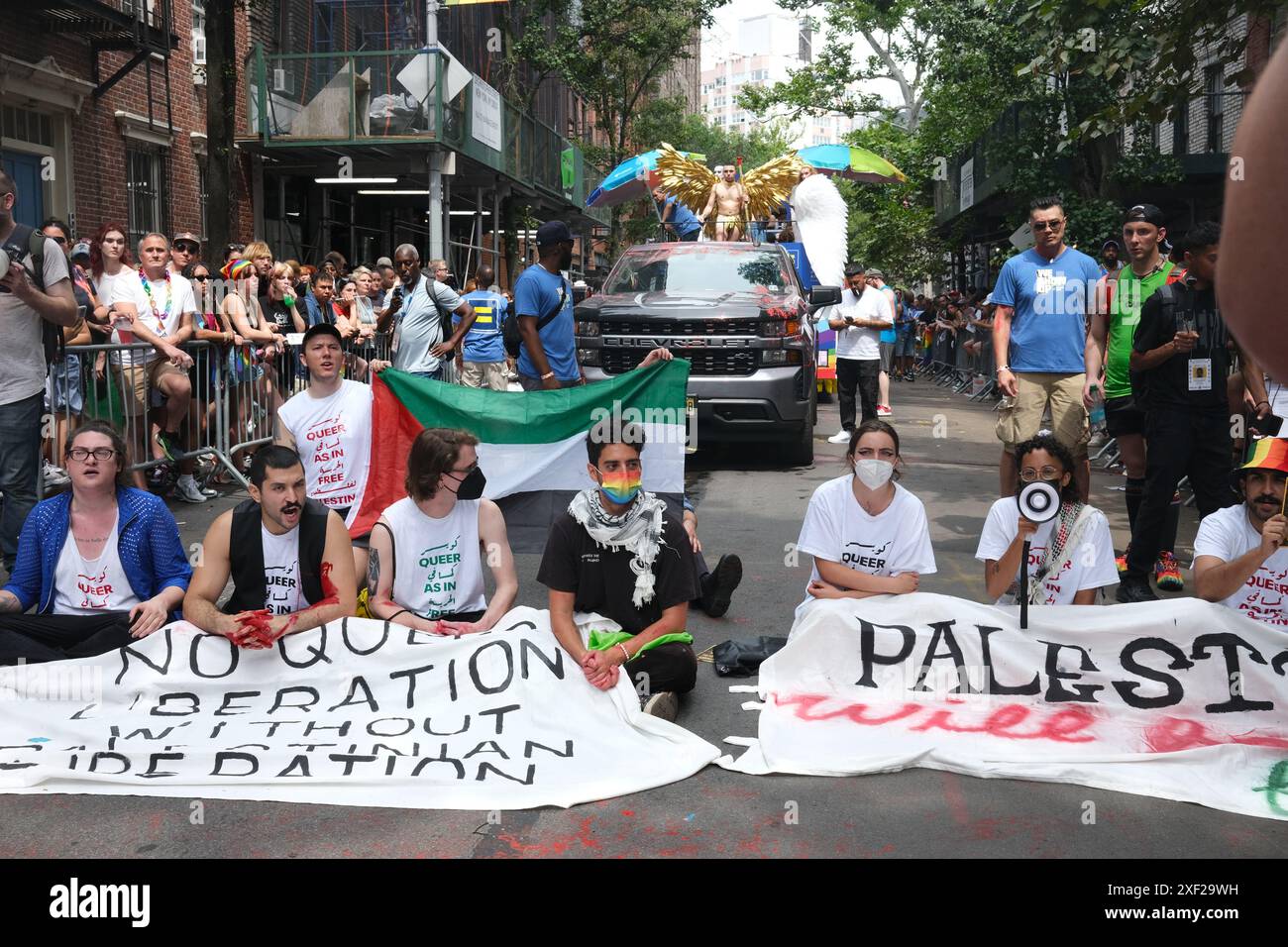 Free Palestine protesters block the path of the Gay Pride parade on ...