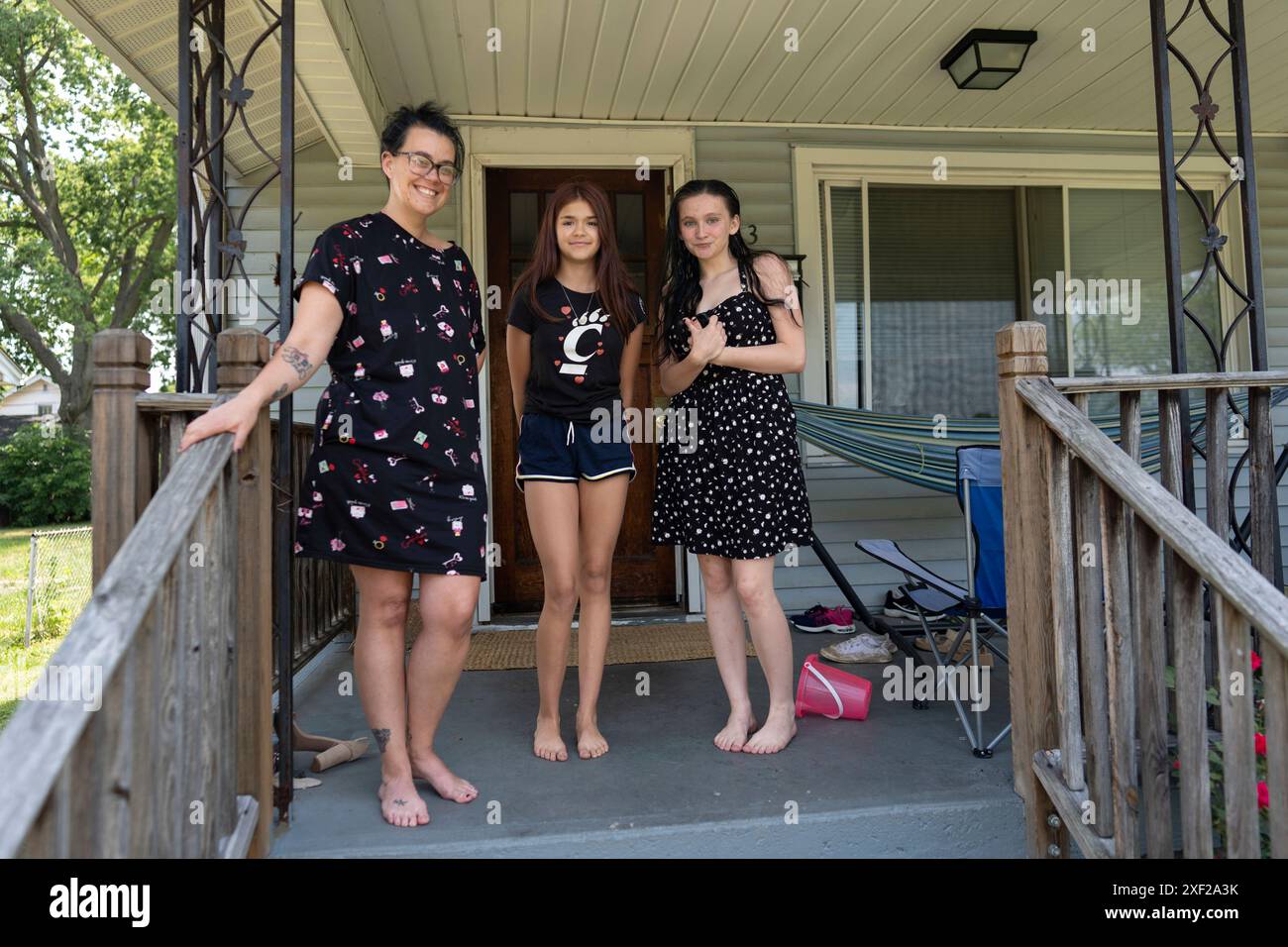 Amanda Bailey, 35, from left, stands on her front porch with her ...