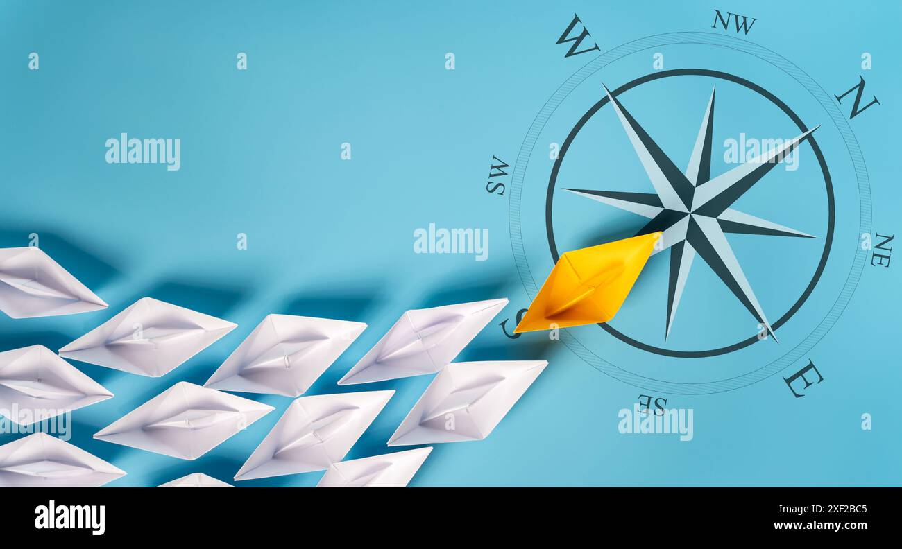 Yellow Paper Boat On Compass Leading A Fleet Of Small White Boats ...